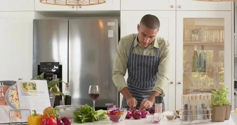 Biracial male cooking vlogger in apron t... | Stock Video | Pond5