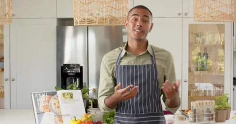Biracial male cooking vlogger in apron t... | Stock Video | Pond5