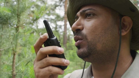 Biracial Male Forest Ranger Talking on P... | Stock Video | Pond5