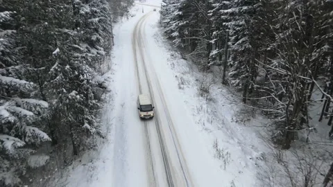 Birds eye view of car driving on on snow... | Stock Video | Pond5
