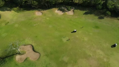 Bird's-eye view of golfers moving across... | Stock Video | Pond5