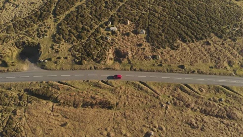 Bird's eye view of red car driving along... | Stock Video | Pond5
