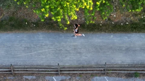 Birds eye view of a young woman running.... | Stock Video | Pond5