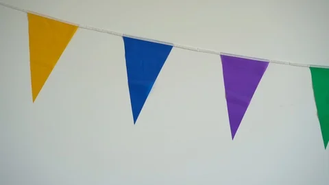 Birthday decoration flags on a plain whi... | Stock Video | Pond5