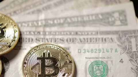 Bitcoins on dollar bill background | Stock Video | Pond5