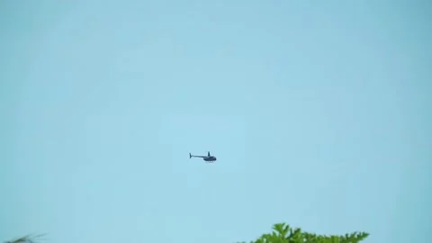 black chopper helicopter flying from a f... | Stock Video | Pond5