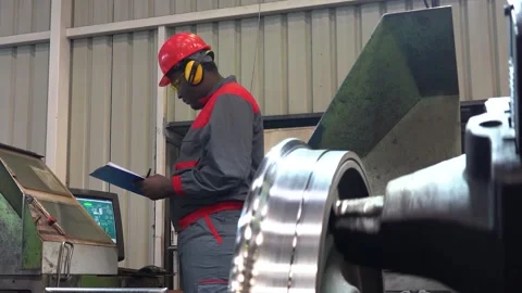 Black CNC Machine Operator Beside CNC Co... | Stock Video | Pond5