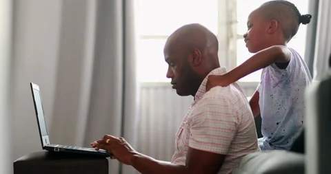 Black dad using laptop with child son do... | Stock Video | Pond5