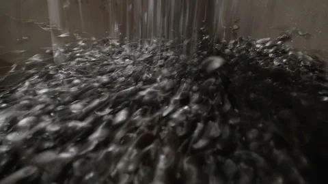 Black granules falling into the machine ... | Stock Video | Pond5