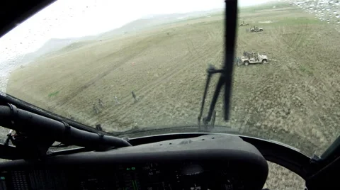 Black Hawk flying over field with Humvee... | Stock Video | Pond5