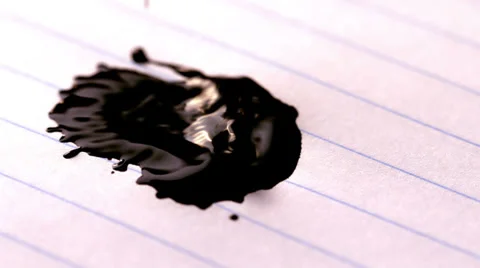 Black ink falling on lined paper | Stock Video | Pond5