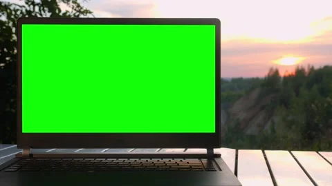 Black laptop with a green screen is on a... | Stock Video | Pond5