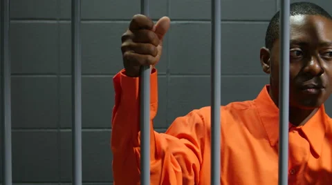 Black male inmate in jail cell, eyes dow... | Stock Video | Pond5
