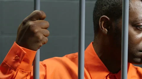 Black male inmate in jail cell, eyes dow... | Stock Video | Pond5