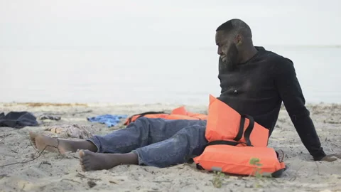 Black man crying hugging life jacket, su... | Stock Video | Pond5
