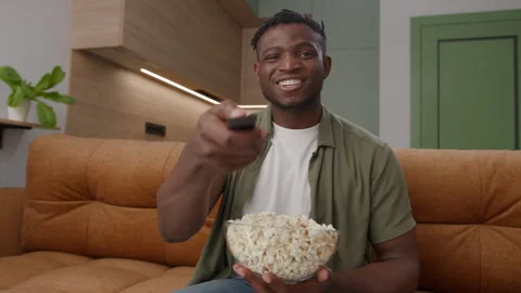 Black Man Eating Popcorn Sitting on Couc... | Stock Video | Pond5