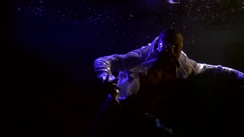 black man is floating inside water of sw... | Stock Video | Pond5