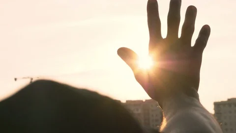 Black man hand covering sun light at sun... | Stock Video | Pond5
