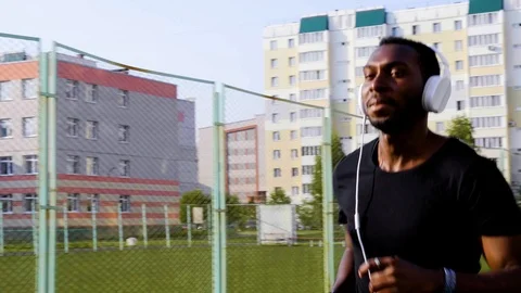 Black man running and listening to music... | Stock Video | Pond5