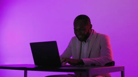 Black Man Sitting at Desk Working on Lap... | Stock Video | Pond5