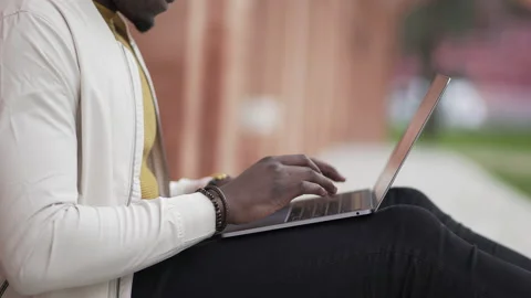 Black man typing on computer laptop sitt... | Stock Video | Pond5