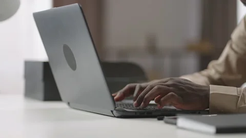 black man is typing on keyboard of lapto... | Stock Video | Pond5