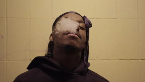 Black rap artist smoking cigarette in un... | Stock Video | Pond5