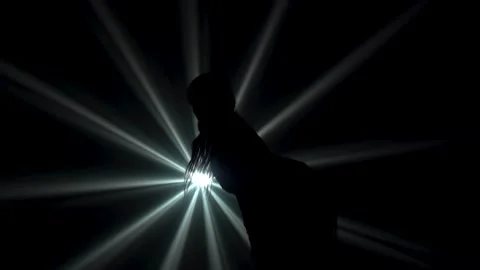 A black silhouette of a woman in a ray o... | Stock Video | Pond5