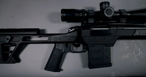 black Sniper Rifle with high powered Sco... | Stock Video | Pond5