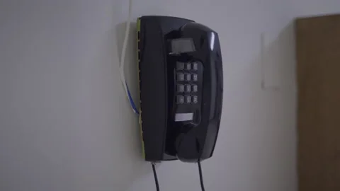 Black Vintage Phone Hanging on a White W... | Stock Video | Pond5