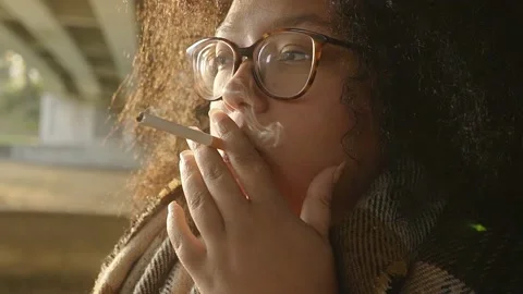 Black woman with curly hair smoking a si... | Stock Video | Pond5