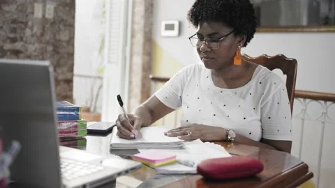 Black woman writing notes and studying a... | Stock Video | Pond5
