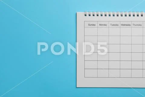 Photograph: Blank calendar on light blue background, top view. Space ...