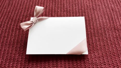 Blank white postcard with pink ribbon on... | Stock Video | Pond5