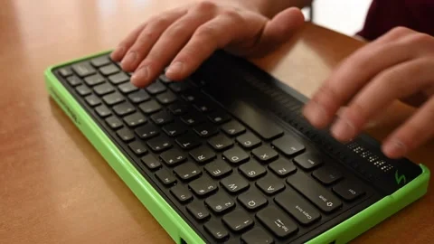 A blind man uses a computer with a Brail... | Stock Video | Pond5