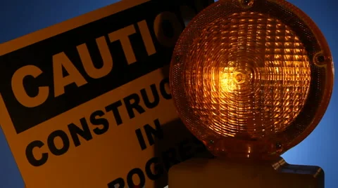 Blinking yellow light with caution sign | Stock Video | Pond5