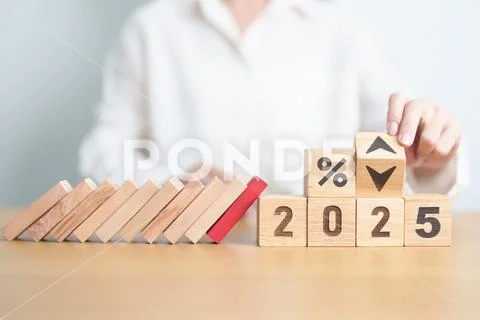 Block falling on 2025 year and percentage UP and Down arrow. Interest ...