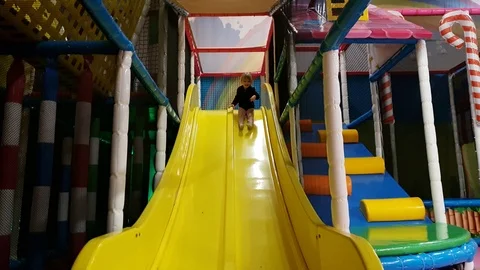 Blond girl having fun in slider at indoo... | Stock Video | Pond5