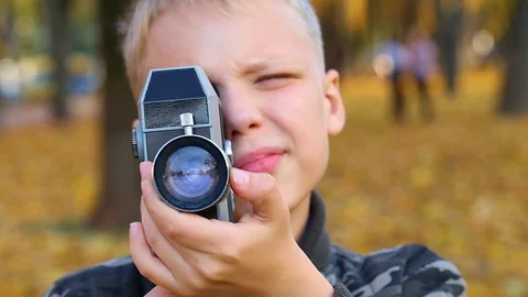 blond white kid holding vintage black ca... | Stock Video | Pond5