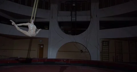 Blonde circus acrobat is hanging on silk... | Stock Video | Pond5