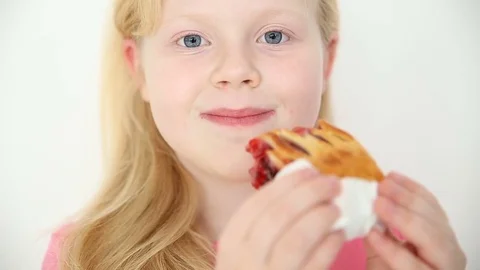blonde girl eats cherry pie on white bac... | Stock Video | Pond5