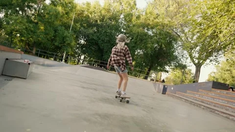 A blonde girl rides fast in a skate park... | Stock Video | Pond5