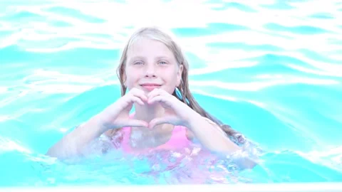 Blonde little girl in a swimming pool. V... | Stock Video | Pond5