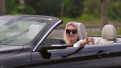 blonde smiling, happily driving car with... | Stock Video | Pond5