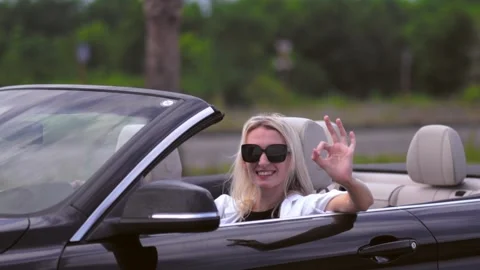 blonde smiling, happily driving car with... | Stock Video | Pond5