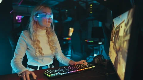 Blonde streamer playing shooter in neon ... | Stock Video | Pond5