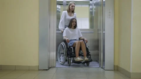 Blonde woman pushes sister in wheelchair... | Stock Video | Pond5