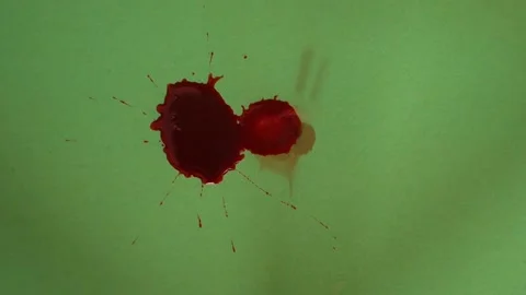blood falling on green background | Stock Video | Pond5
