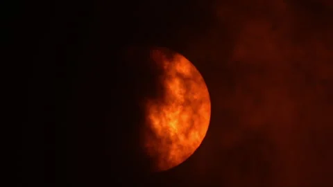 Bloody Sun covered by black clouds. Apoc... | Stock Video | Pond5