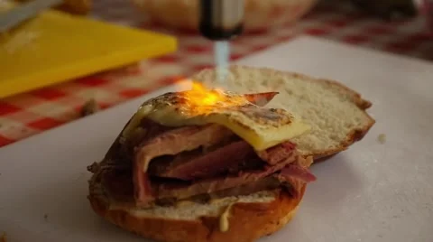 Blow torch cheese on a burger HD | Stock Video | Pond5